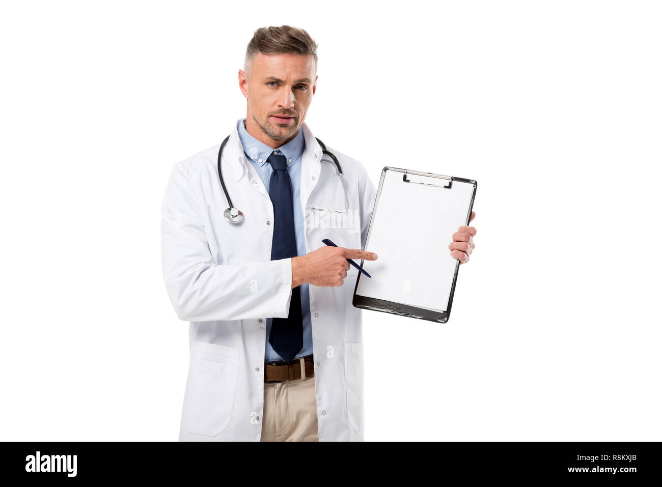 serious doctor with pen looking at camera and pointing at diagnosis ...
