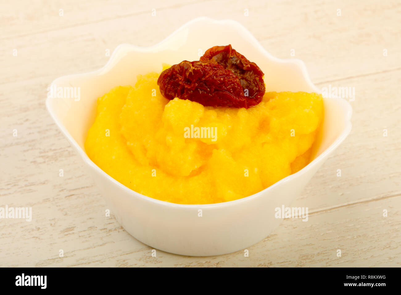 Polenta with dry tomato Stock Photo - Alamy