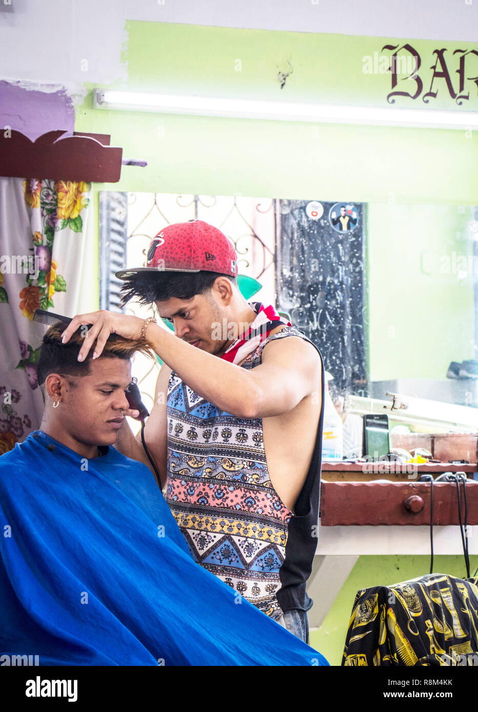 young Cuban barber giving man haircut and shave in Havana Cuba Stock ...