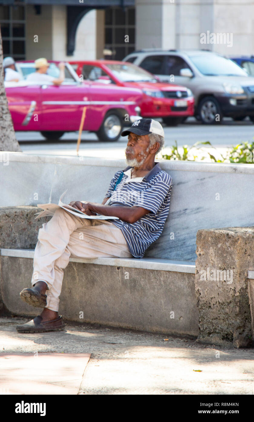 elderly cuban man in cap sits in square in Havana Cuba Stock Photo - Alamy