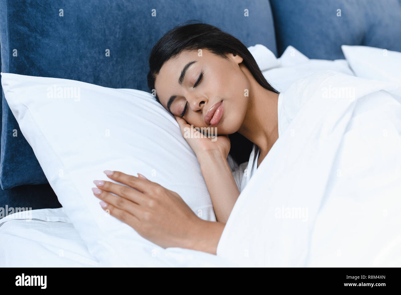beautiful mixed race girl sleeping on bed in morning Stock Photo - Alamy