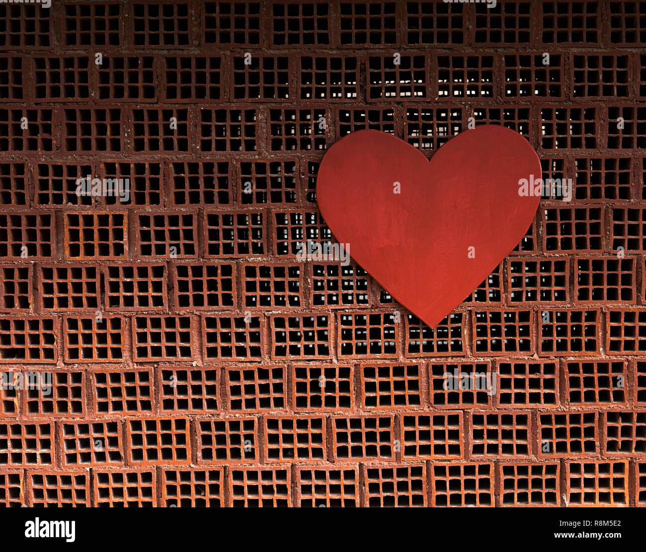 Big red heart on a stacked wall bricks Stock Photo - Alamy