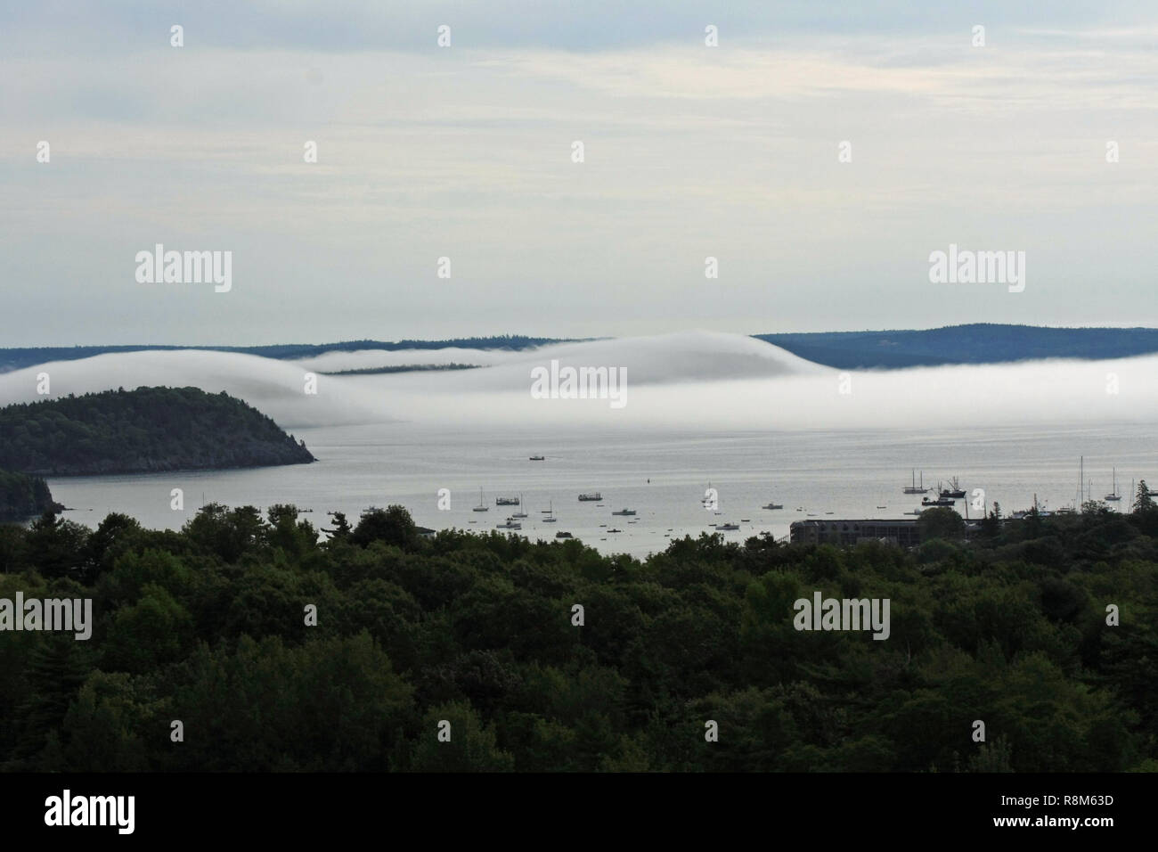 Dense fog rolling into Bar Harbor, Maine, covering islands in the ...