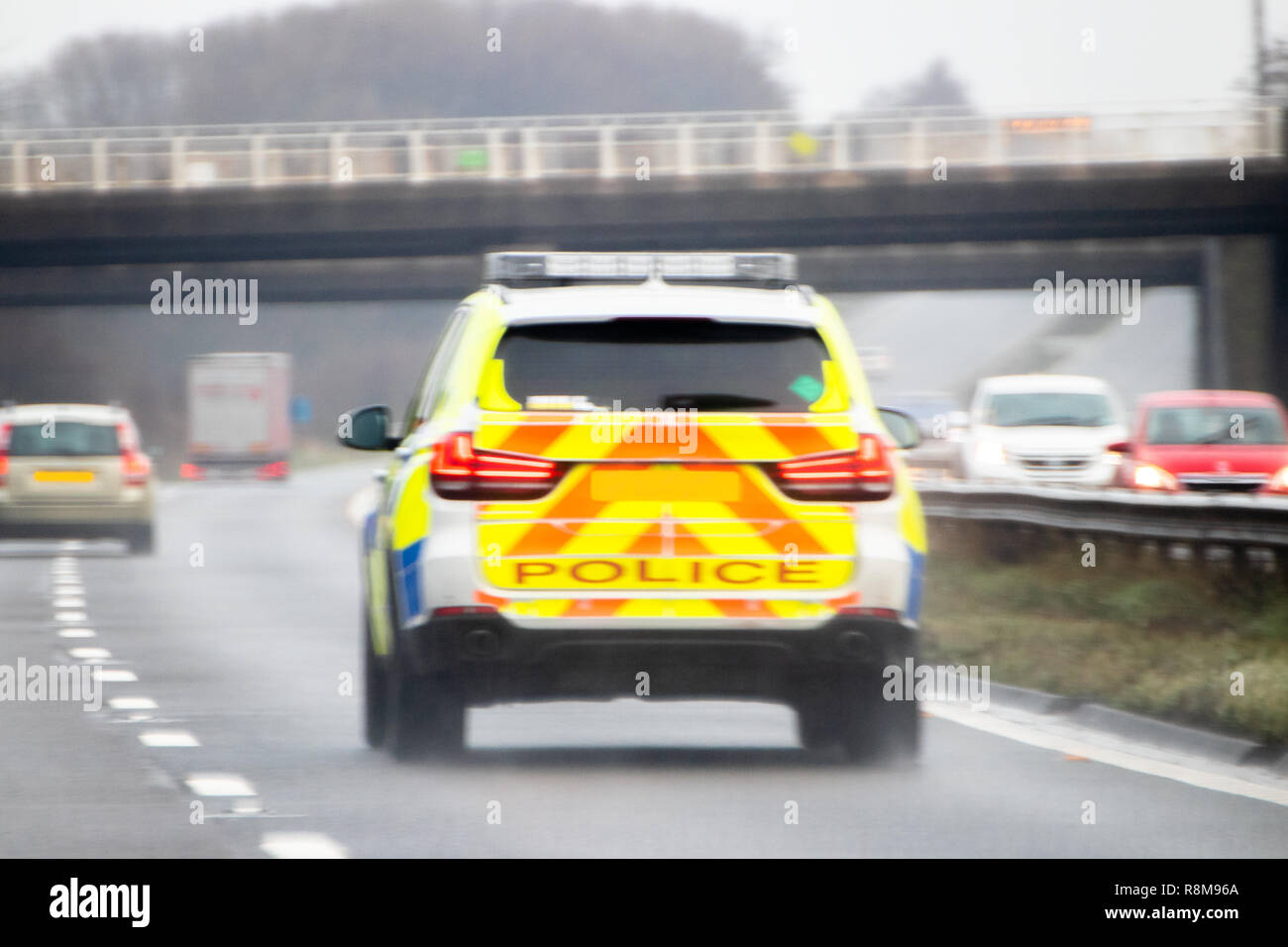 Police Car SUV speeding down motorway / freeway on fast lane. British ...