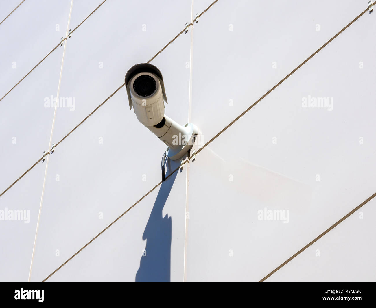 Surveillance camera mounted on a wall lined with ceramic tiles Stock ...