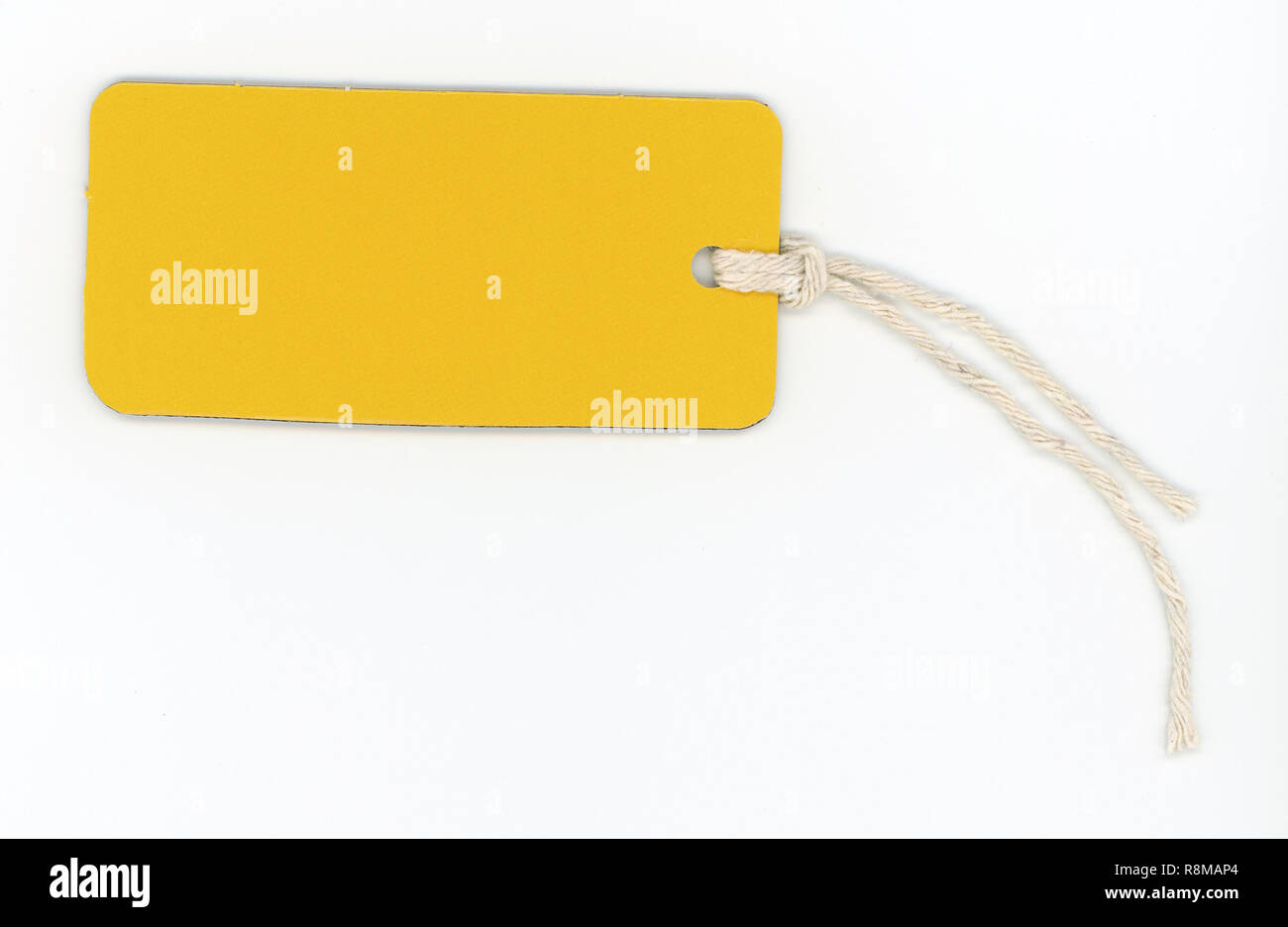 yellow paper tag label for product information Stock Photo - Alamy
