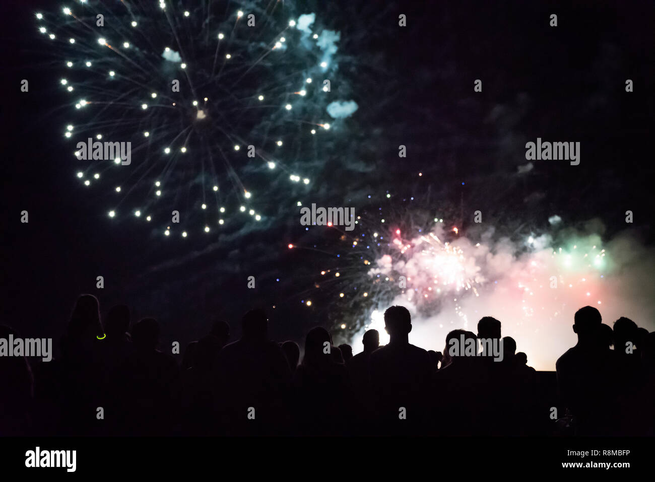New year concept - cheering crowd and fireworks Stock Photo - Alamy