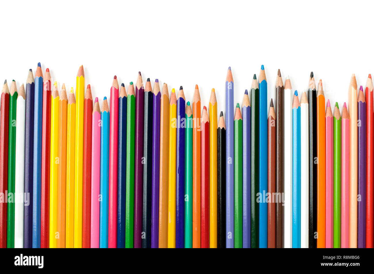 Colored pencils in a row on white background Stock Photo - Alamy