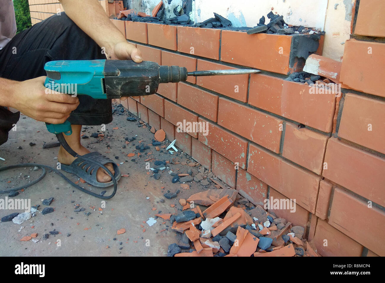 The builder dismantles the brick in the wall with a punch 2018 Stock ...