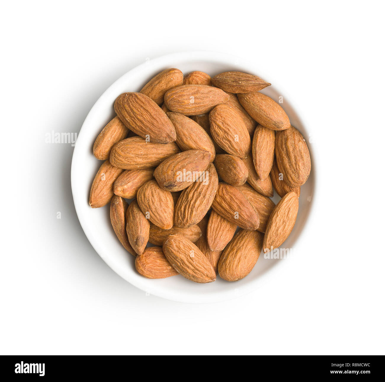 Dried almond nuts in bowl isolated on white background Stock Photo - Alamy