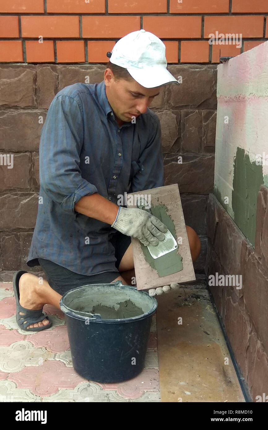 Professional worker gluing decorative hi-res stock photography and ...