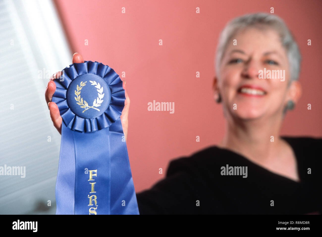 Mature woman woman showing her blue ribbon prize, USA Stock Photo - Alamy