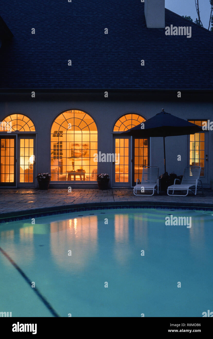 Residential home at night with lit windows, USA 1998 Stock Photo - Alamy