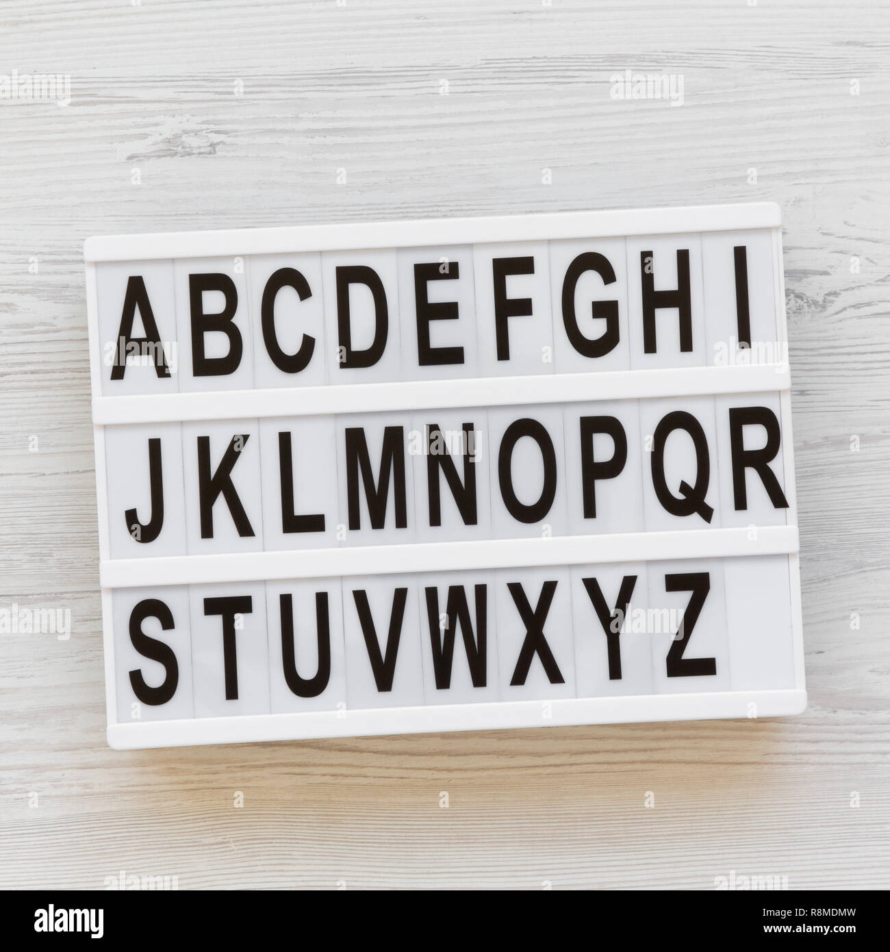 Letters from A to Z. English alphabet on modern board over white wooden ...