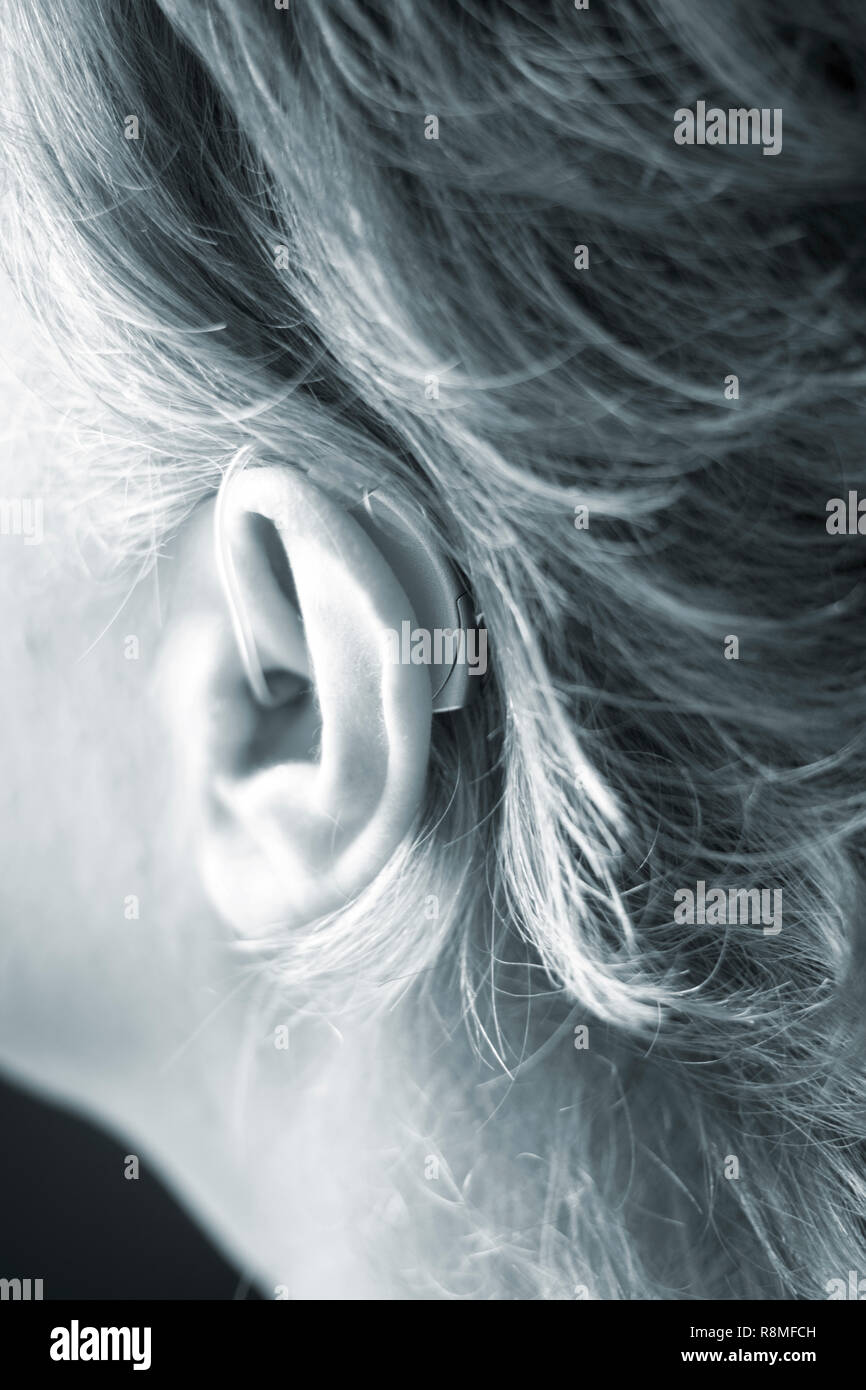 Deaf lady with modern technology digital hearing aid in her ear Stock ...