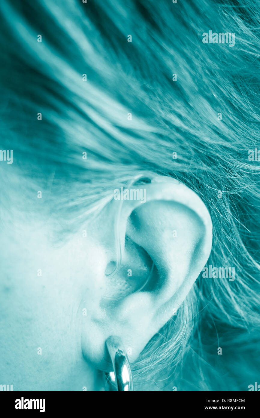 Deaf lady with modern technology digital hearing aid in her ear Stock ...