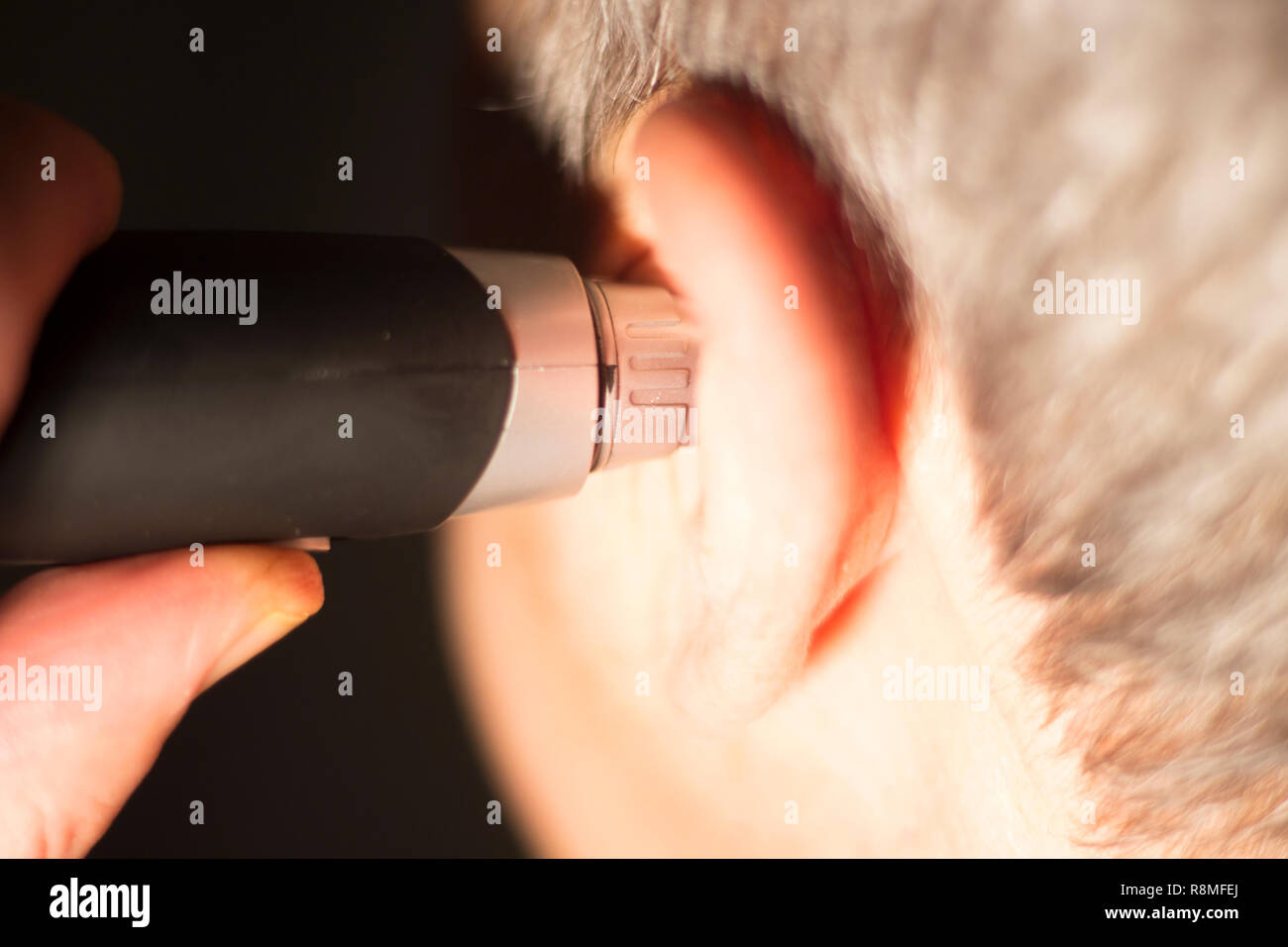 Senior citizen man cutting inner ear hair with electric cutter Stock ...