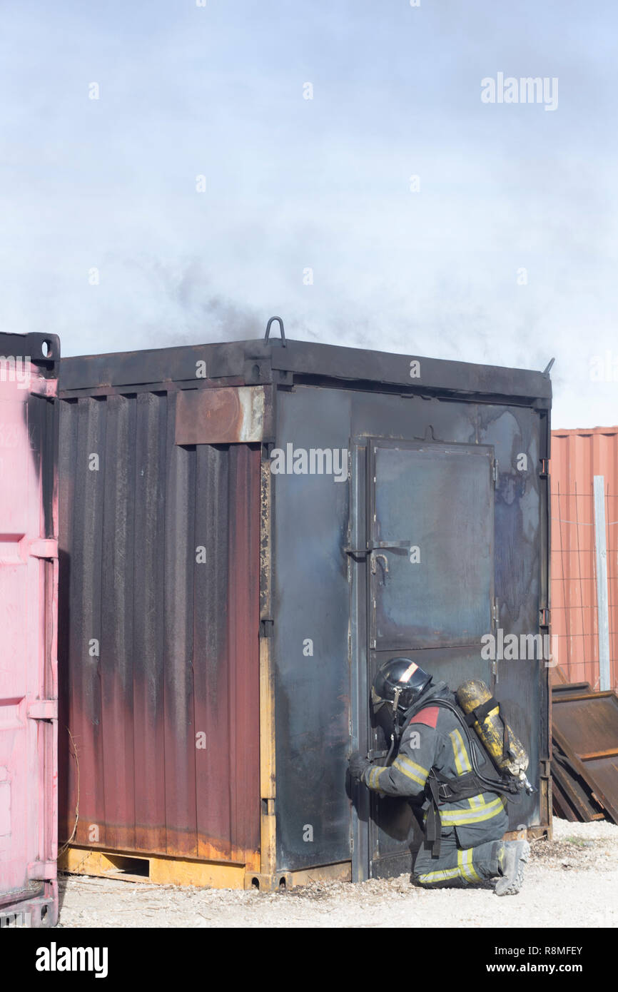 Firefighter putting out fire training station extinguisher backdraft ...