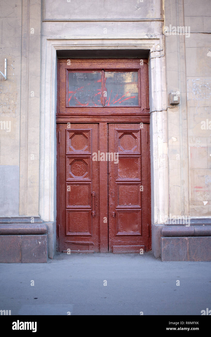Closed stone building door in bad condition painted brown color ...