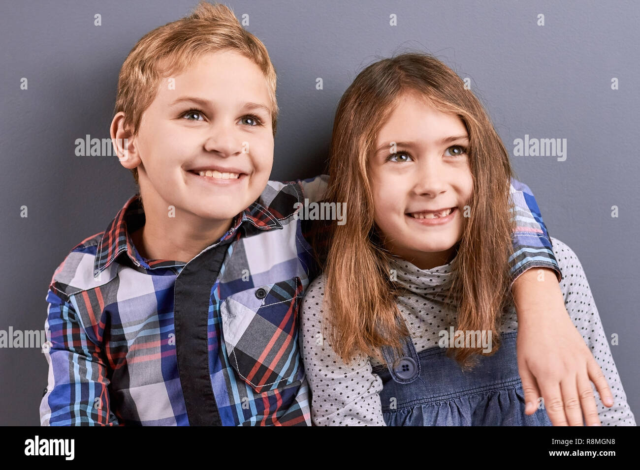 Little brother smiling and hugging sister Stock Photo - Alamy