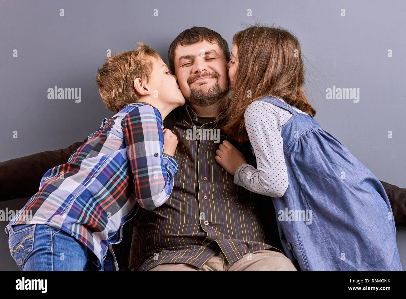 Caucasian happy family, gray background Stock Photo - Alamy