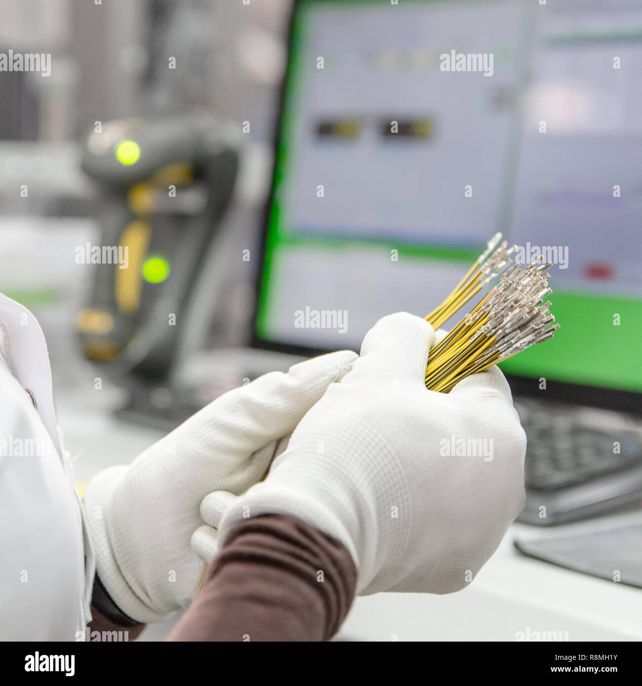 Employee checks the quality of the product, bunch of sliced wires with ...