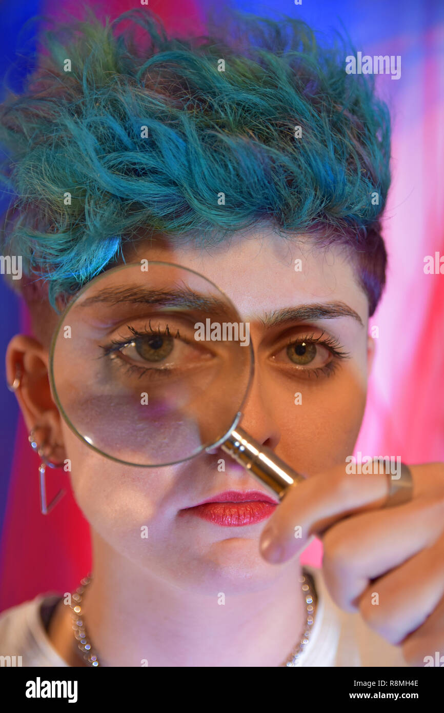 Young girl poses with a magnifying glass on the eye Stock Photo - Alamy
