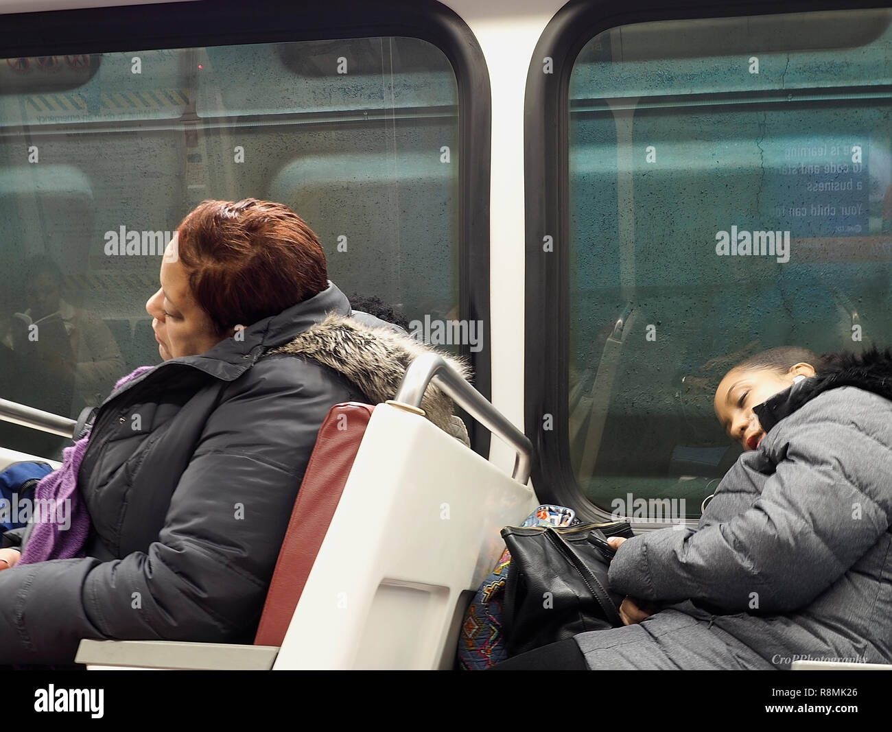 Two women asleep on metro train Stock Photo - Alamy