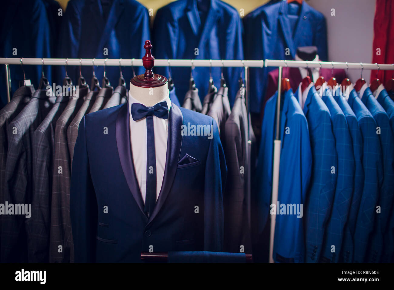 Row men suit jackets on hangers Stock Photo - Alamy