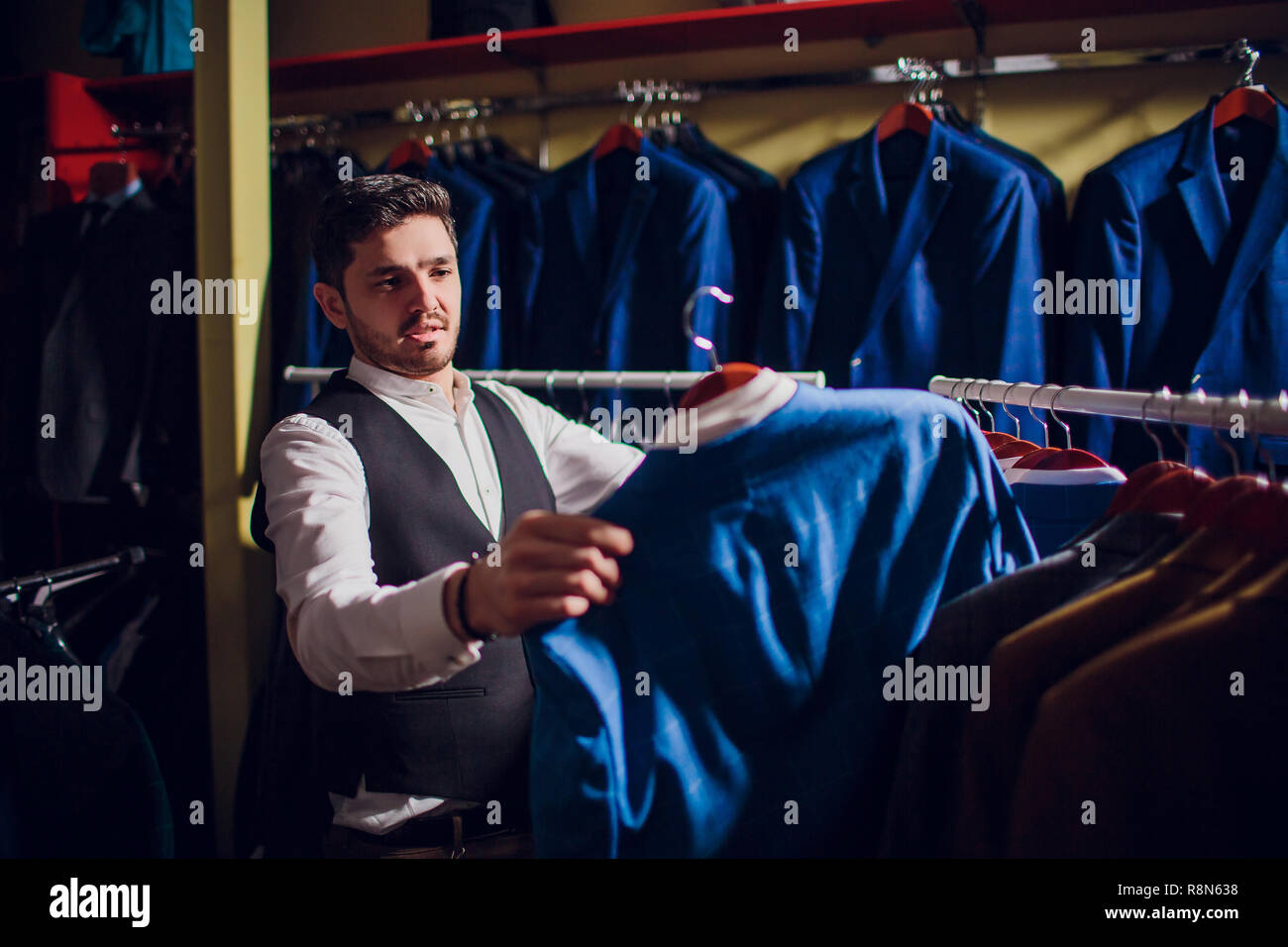 Mens suits on rack hi-res stock photography and images - Alamy