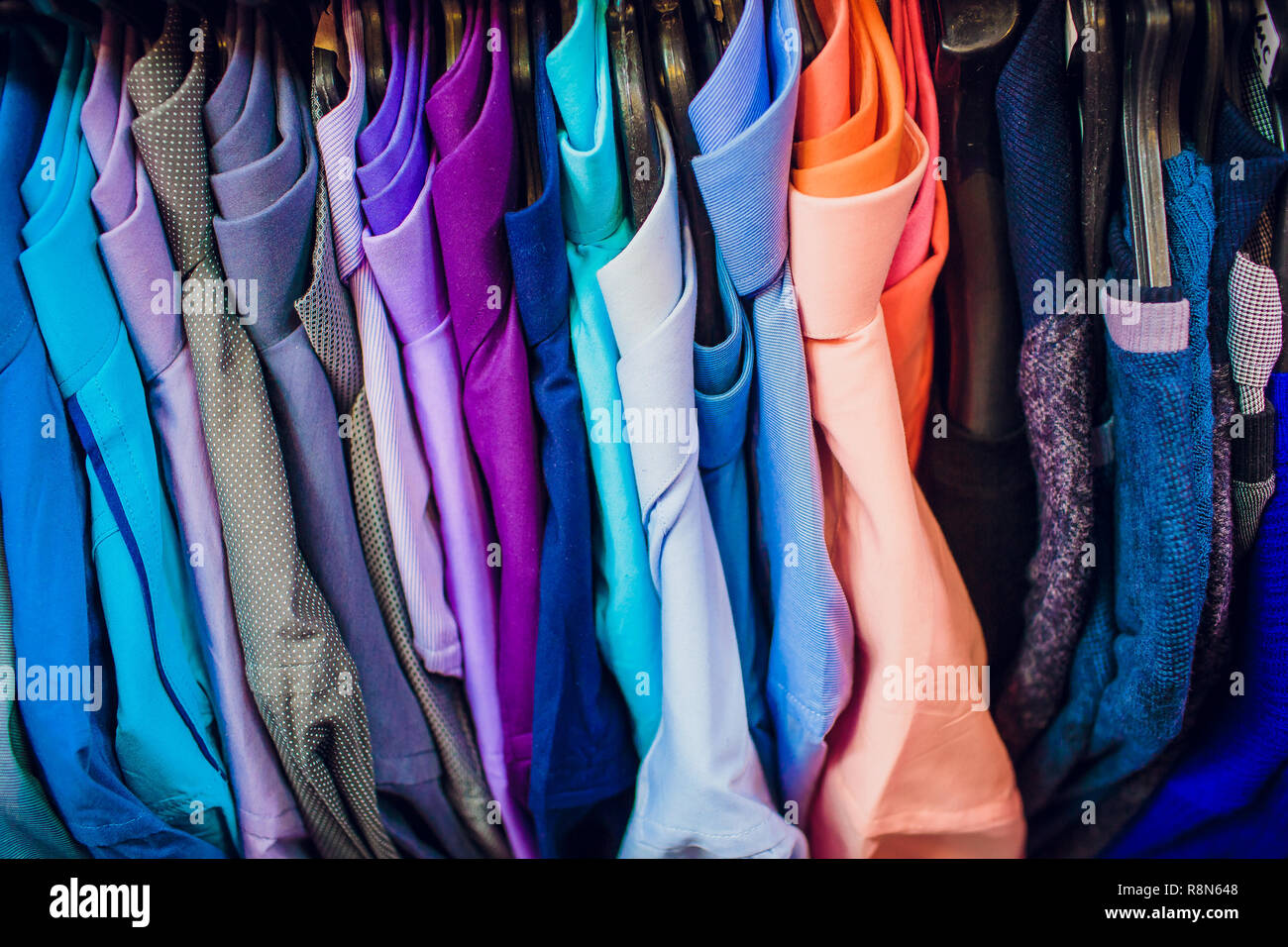 Big clothing store, many rows with hangers with pants and t-shirts ...