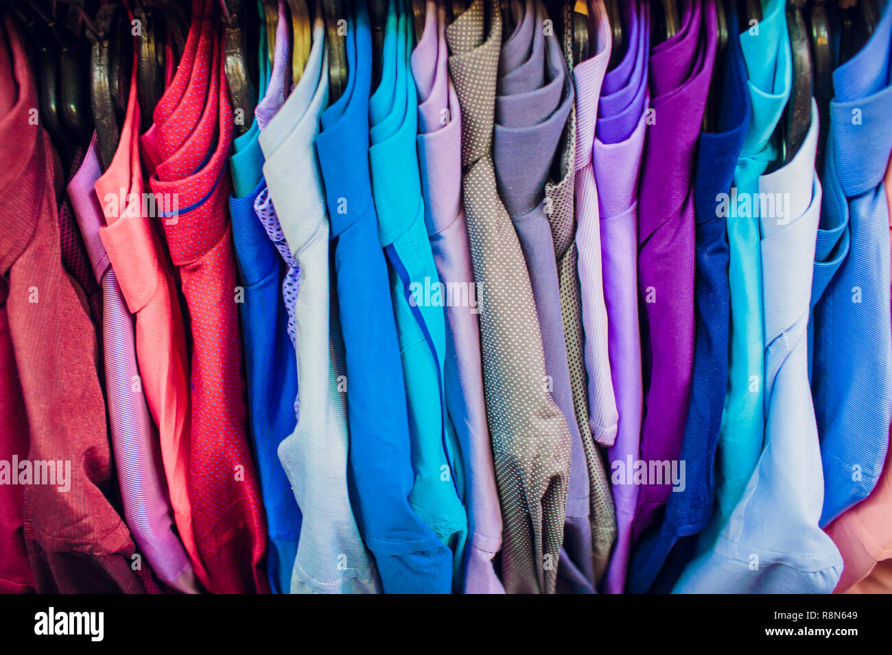 Big clothing store, many rows with hangers with pants and t-shirts ...