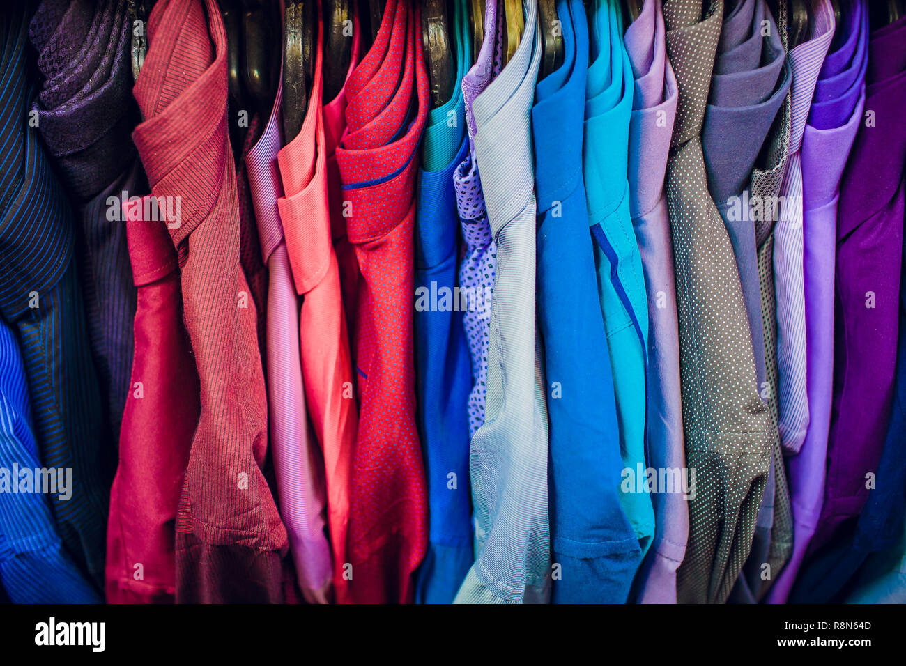 Big clothing store, many rows with hangers with pants and t-shirts ...