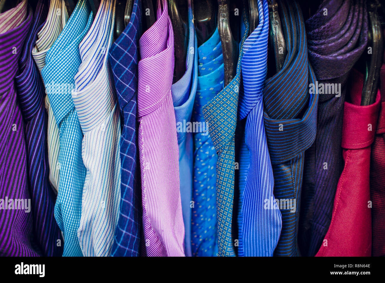 Big clothing store, many rows with hangers with pants and t-shirts ...