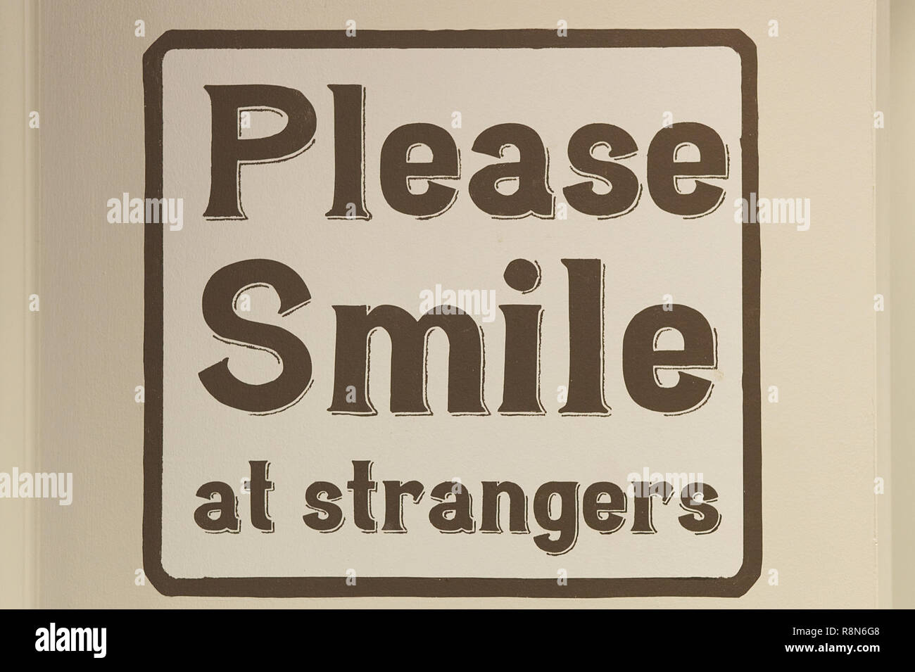 Please smile at strangers sign Stock Photo - Alamy