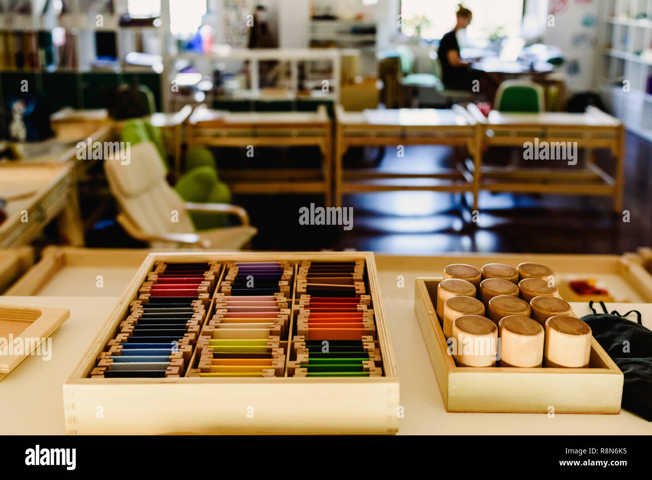 Table and shelving with montessori material, colored items and wooden ...