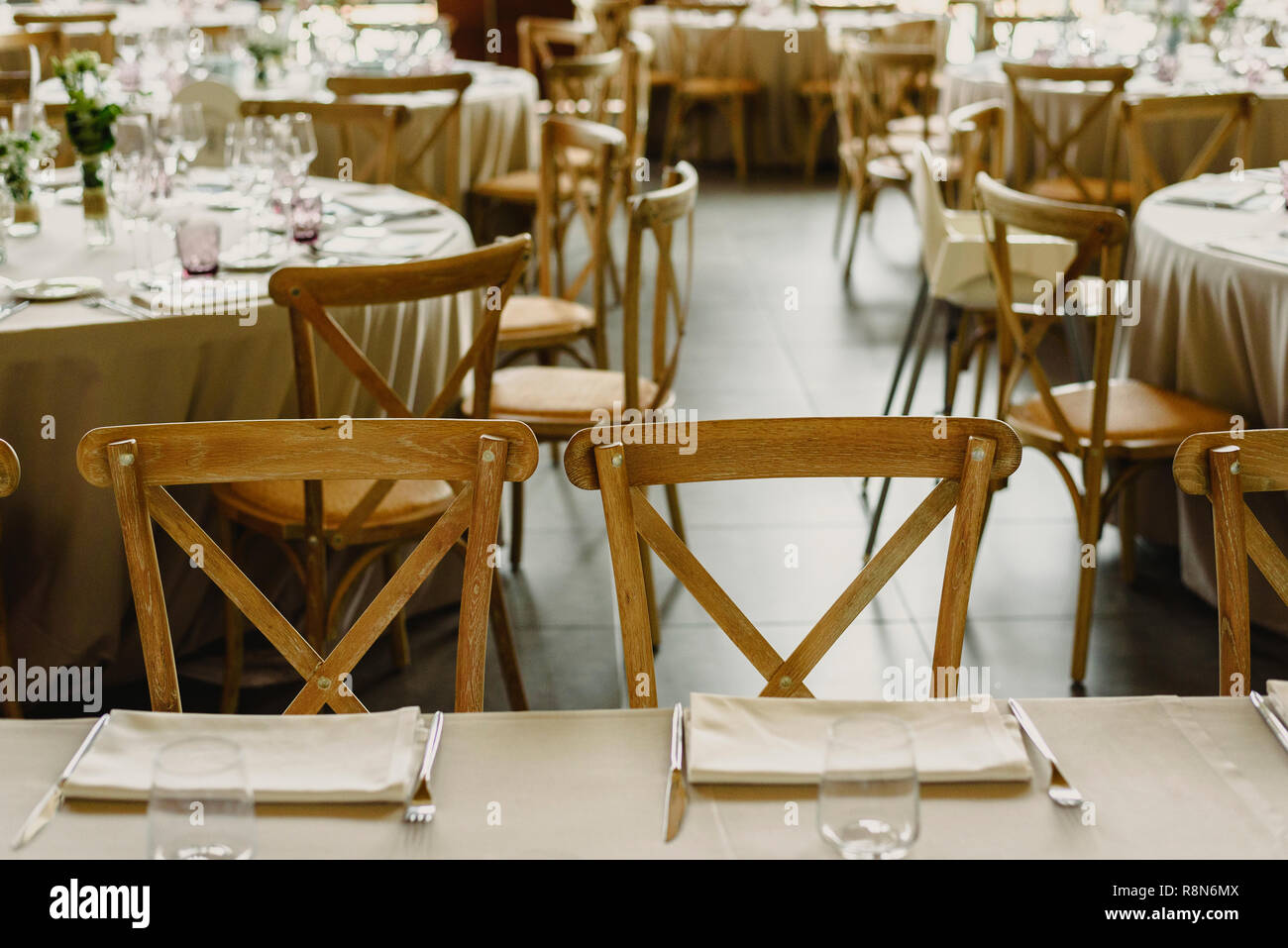 Empty lounge of a restaurant with tables, chairs and retro cutlery ...
