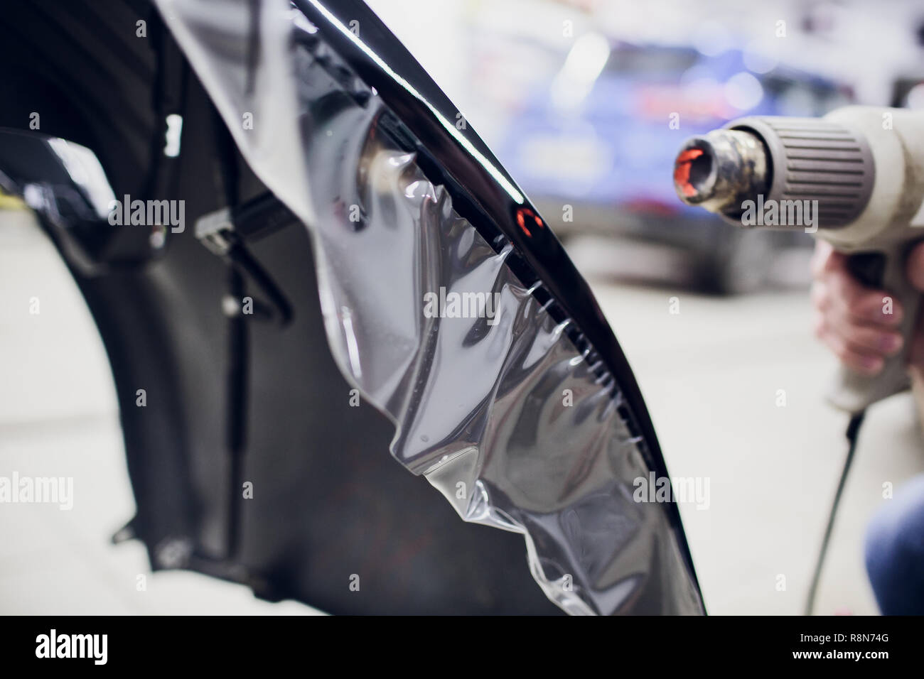 Worker hands installs car paint protection film wrap bumper Stock Photo ...