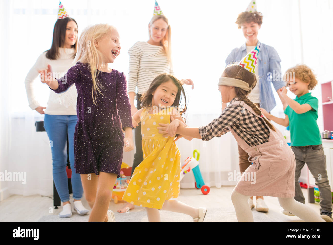 Carefree girls running while playing blind mans buff Stock Photo - Alamy