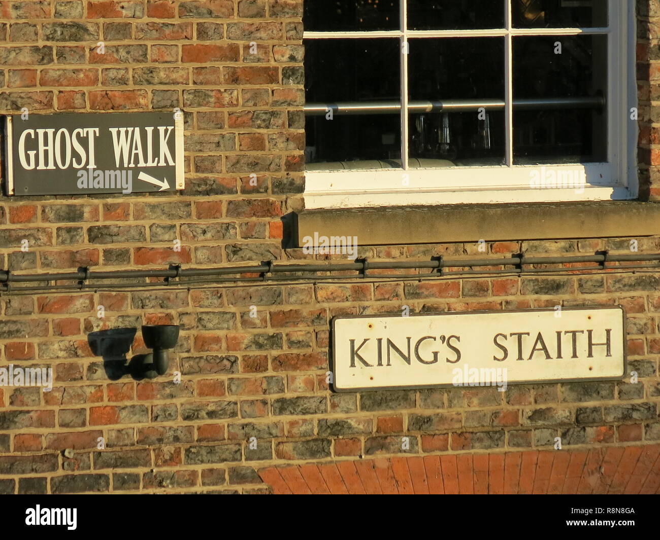 Street signs saying "KING'S STAITH" and "GHOST WALK " on the side of a ...
