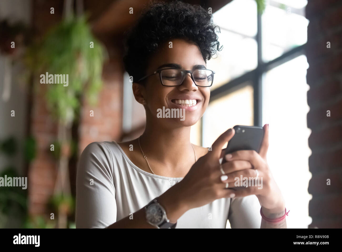 Smiling African American Woman Using Phone Get Good Message Stock