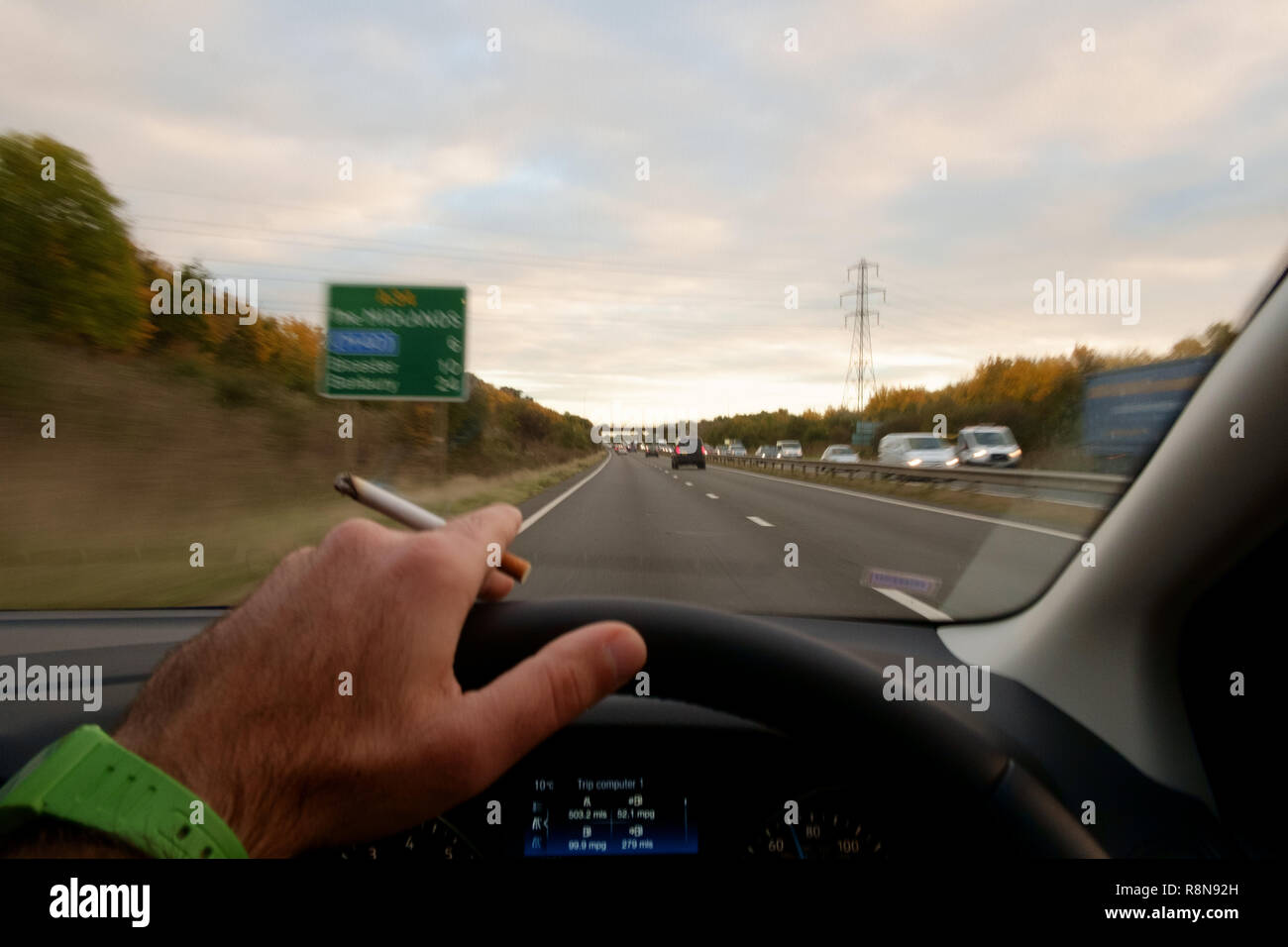 Driving and smoking in a motorway Stock Photo - Alamy