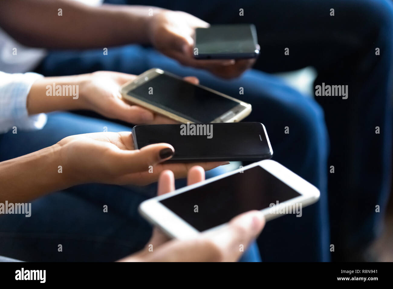 Multiethnic people holding phones in hands screen up close up Stock ...