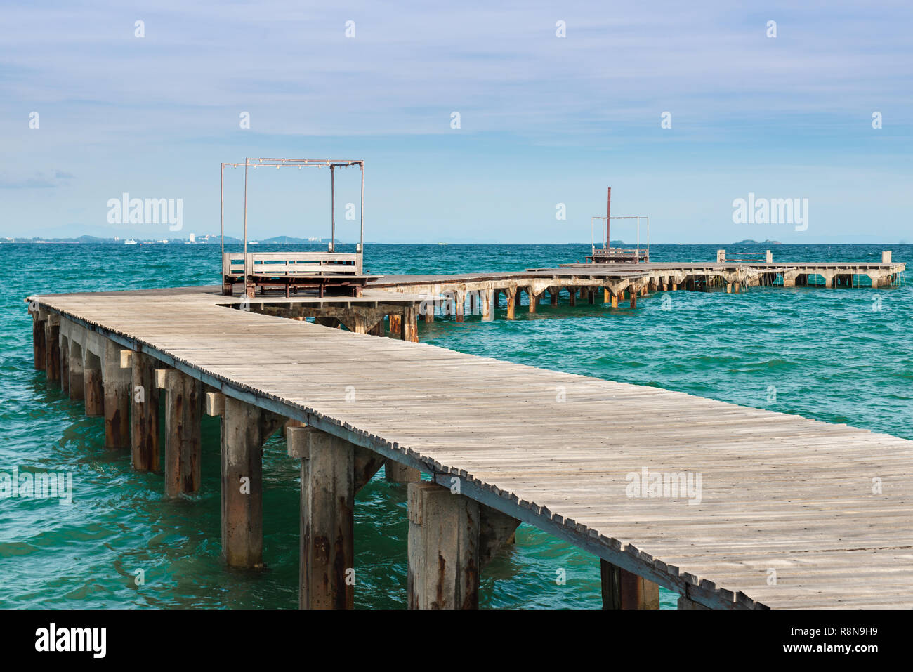 Long wooden sea bridge with outdoor sun lighting Stock Photo - Alamy
