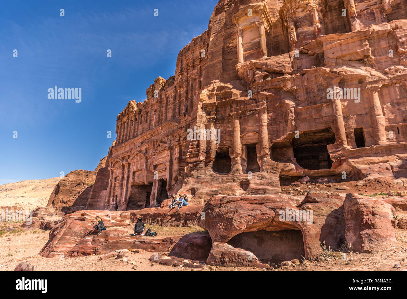 Petra, Jordan - Feb 26th 2018 - A group of tourist sitting in front of ...