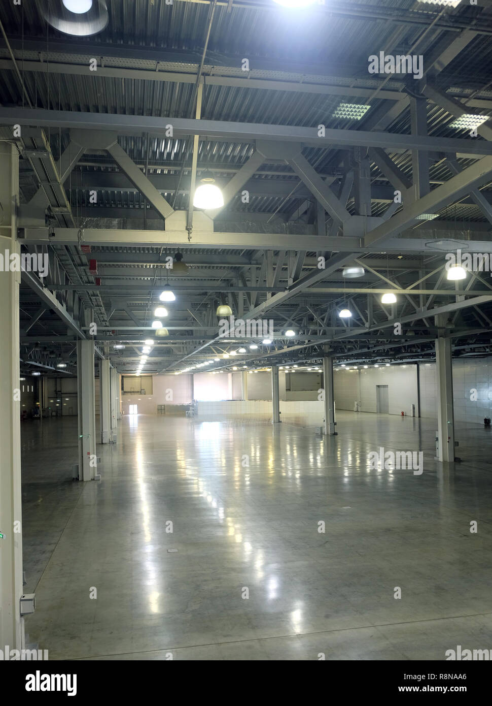Large empty warehouse interior in an industrial building with high ...