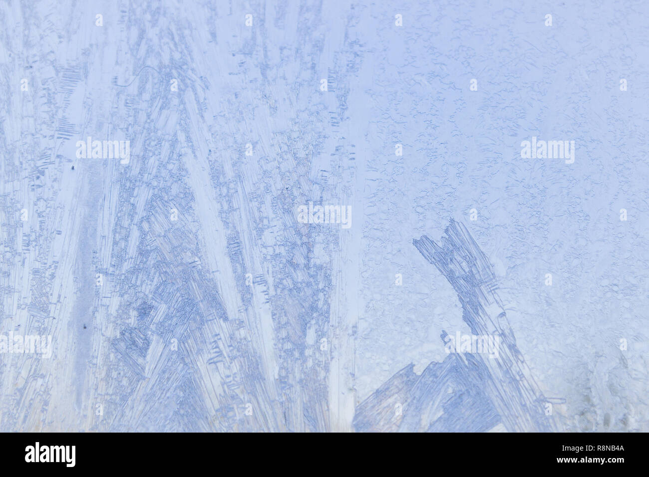 Painted developed frosty patterns on the winter ice window Stock Photo ...