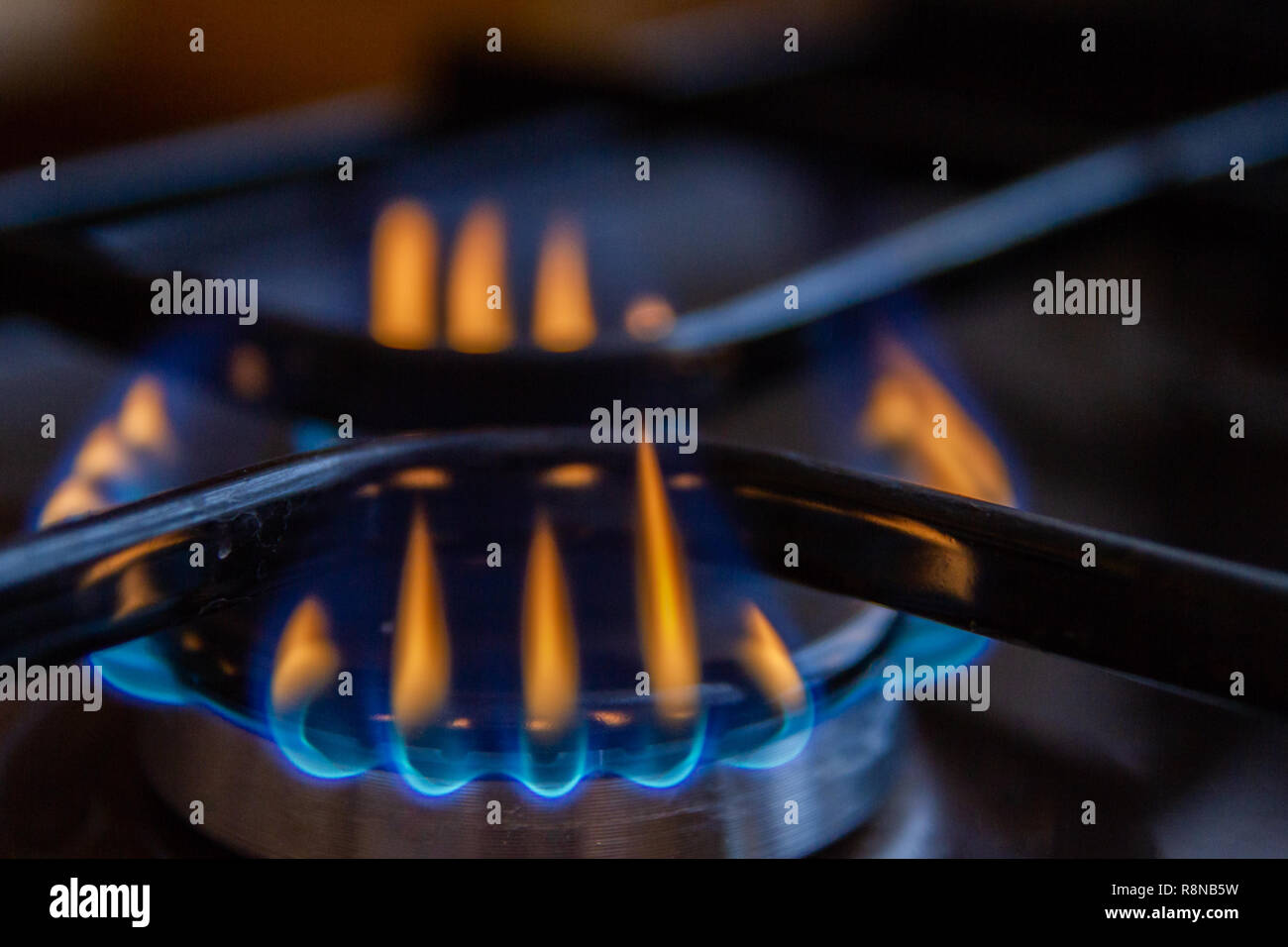 Gas stove with burning orange and blue fire on it Stock Photo - Alamy