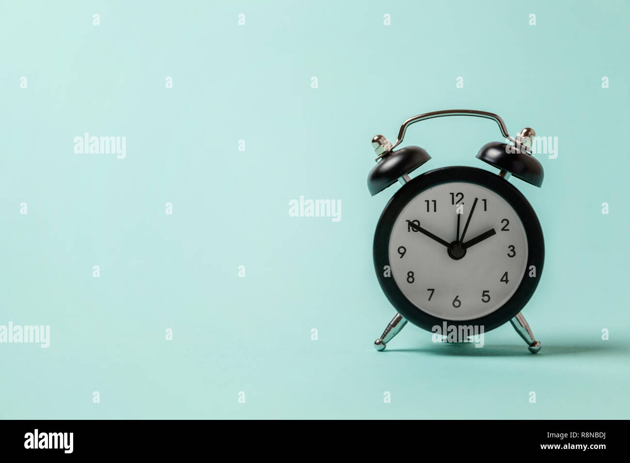 Ringing twin bell vintage classic alarm clock Isolated on blue pastel ...