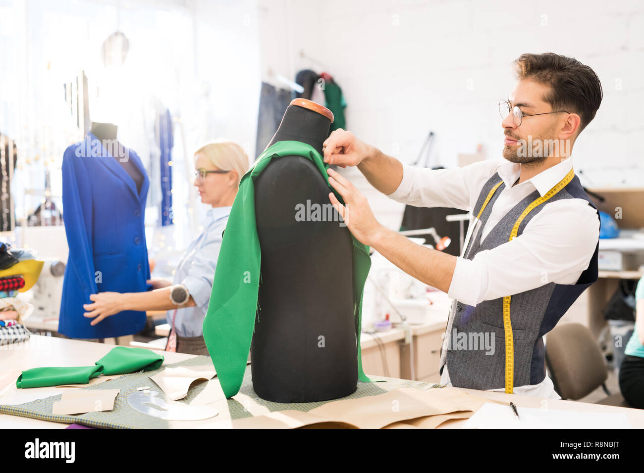 Fashion Designer Working in Atelier Stock Photo - Alamy